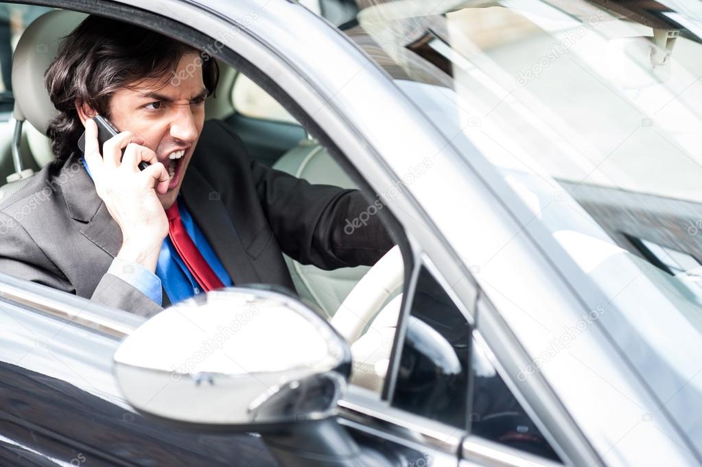 Angry businessman shouting while driving Stock Photo by ©stockyimages ...