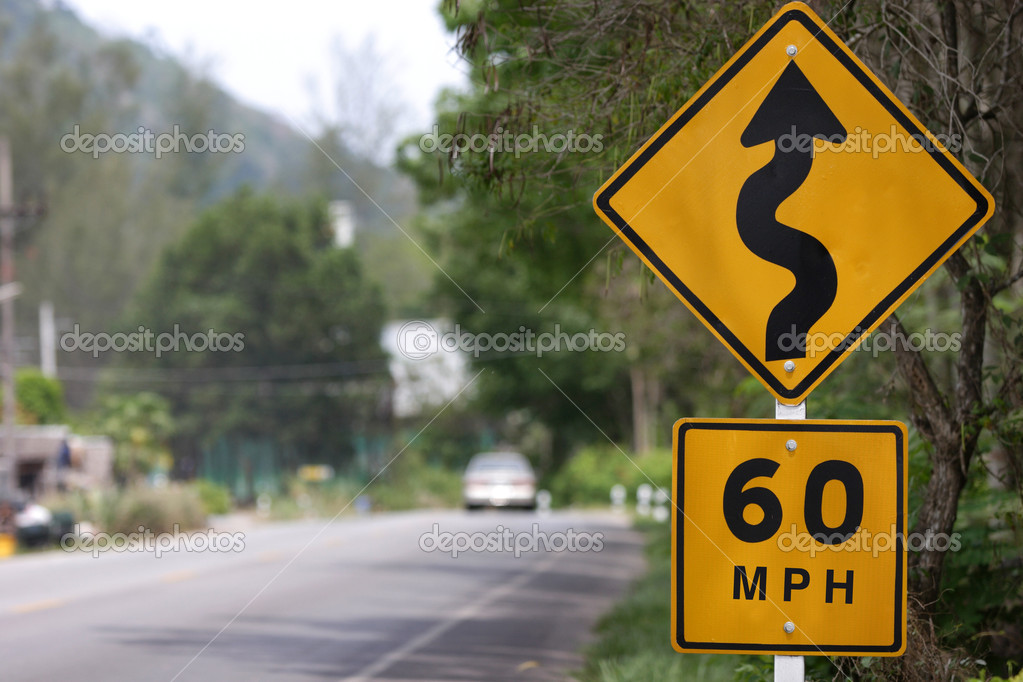 Speed limit sign and winding Road Sign Stock Photo by ©potowizard 19510255