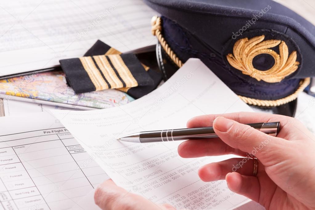 Airplane pilot filling in flight plan Stock Photo by ©Amaviael 21502895
