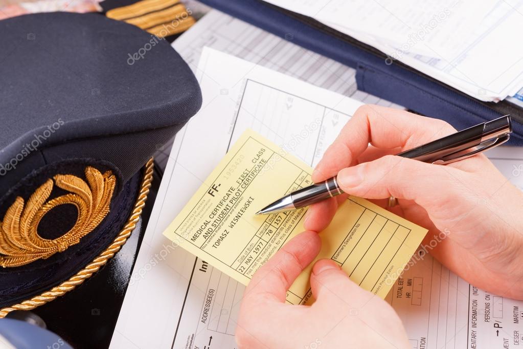 Airplane pilot filling in flight plan Stock Photo by ©Amaviael 21503353