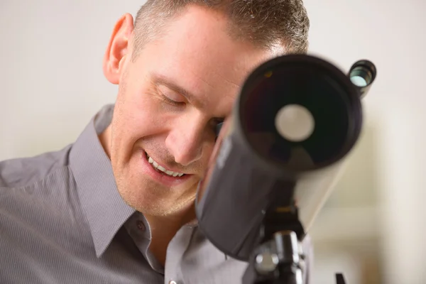 Man looking through telescope - Stock Image - Everypixel