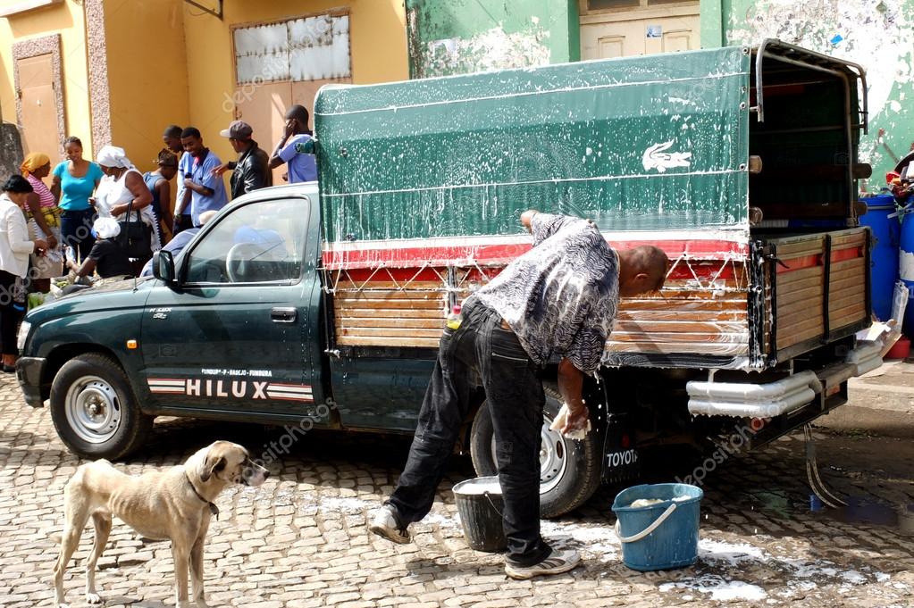Man washing his car in the street. – Stock Editorial Photo © allg #17358399