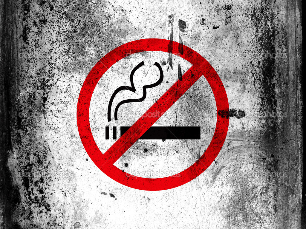 No smoking sign drawn at board with grungy dirty stains all over it ...