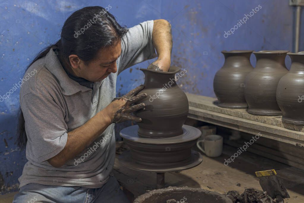 Mexican artisan creating a vase of clay for the talavera process 2023