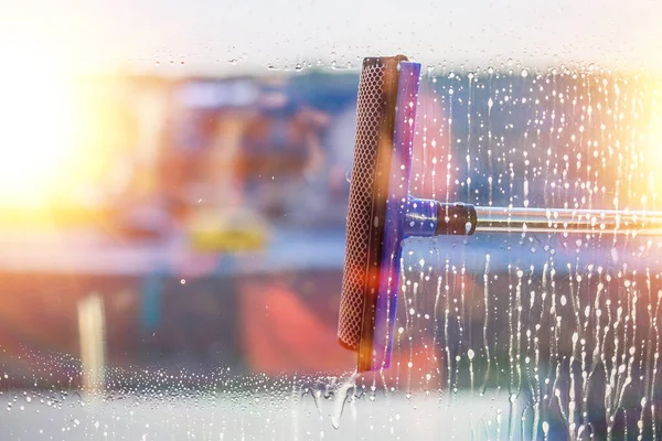 Window cleaning brush. Large window in a multi-storey building ...