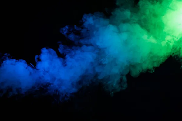 Yellow-blue smoke in neon light on black background. — Stock Photo ...