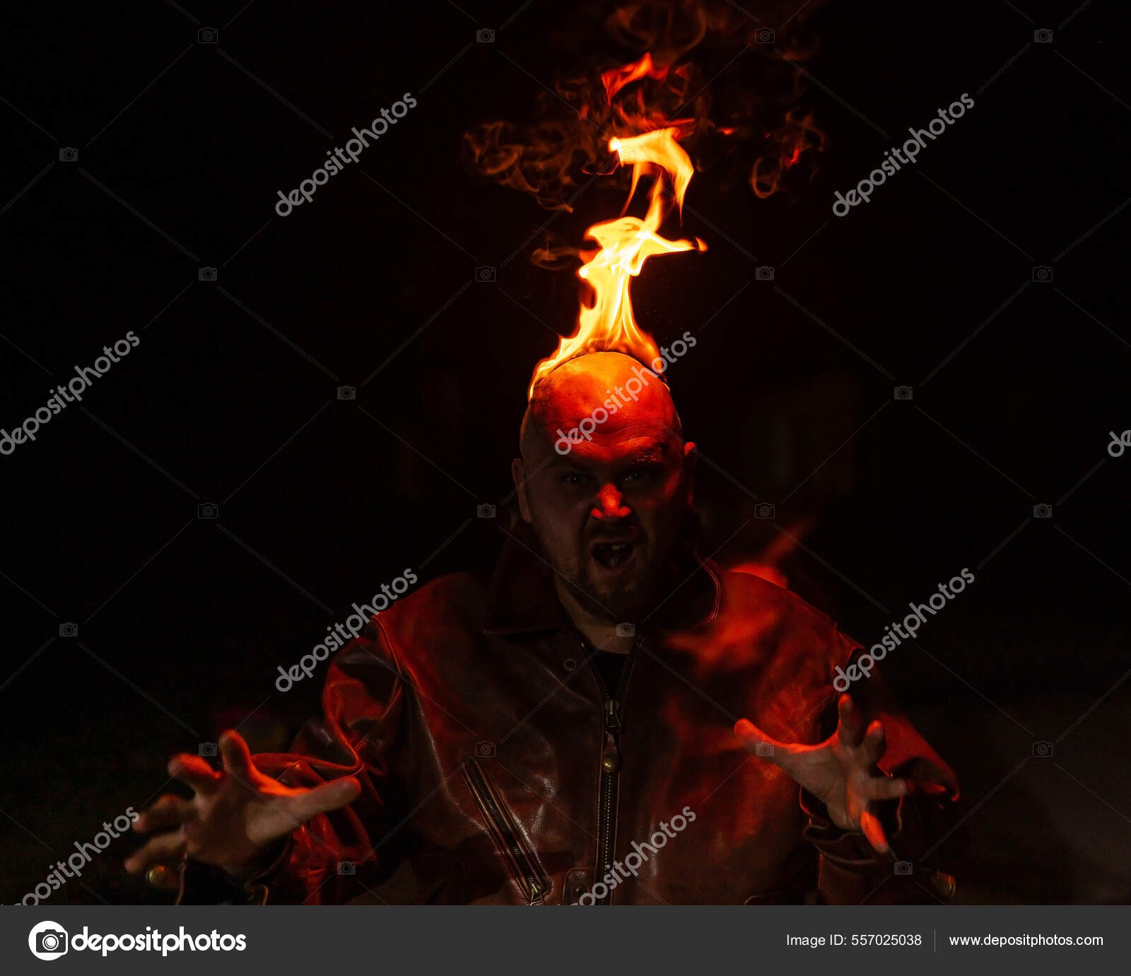 Bald man in a leather jacket with a burning head on a dark background ...