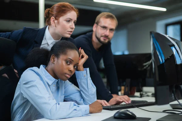 Colleagues look at the monitor and decide working moments. A sad ...