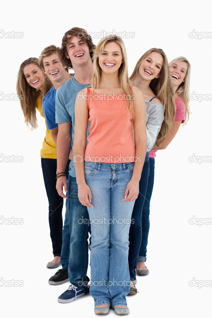 A smiling group of standing and looking at the camera Stock Photo by ...
