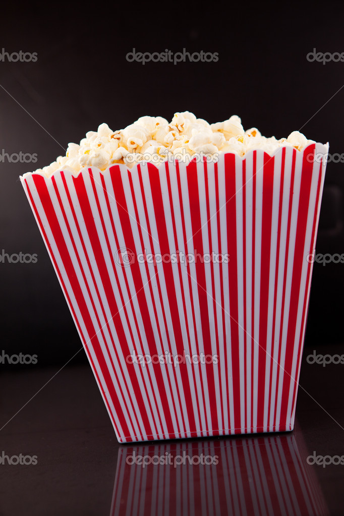 Full box of pop corn on a black table Stock Photo by ©Wavebreakmedia ...