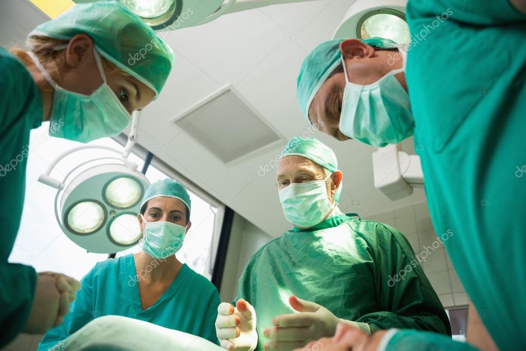 Surgical team working on a bleeding patient — Stock Photo ...