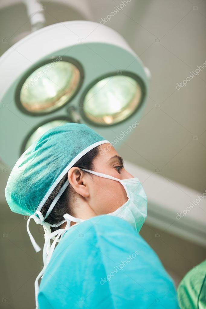Woman surgeon under a surgical light Stock Photo by ©Wavebreakmedia ...