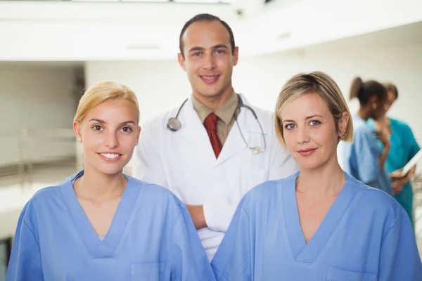 Smiling nurse with two friends — Stock Photo © Wavebreakmedia #23046718