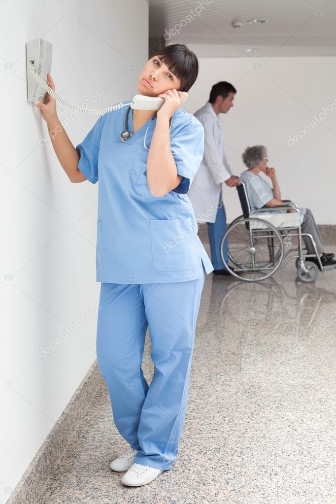 Nurse using telephone — Stock Photo © Wavebreakmedia #23045638