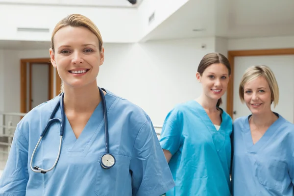 Smiling nurse with two friends Stock Photo by ©Wavebreakmedia 23046718
