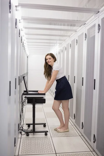 Smiling woman running diagnostics on servers - Stock Image - Everypixel