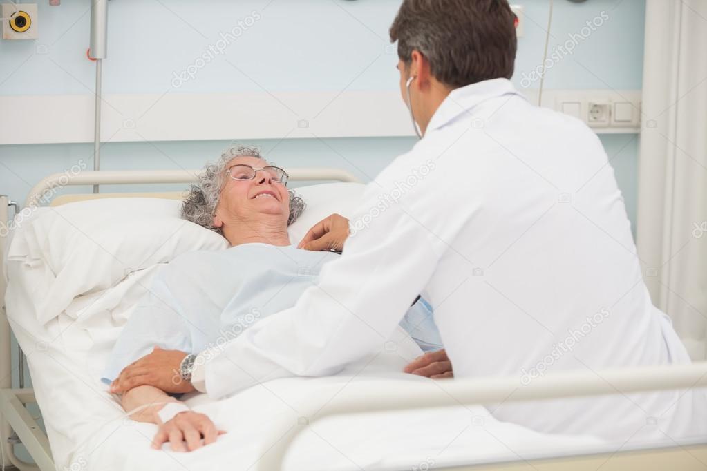 Doctor caring about elderly lady — Stock Photo © Wavebreakmedia #23054338