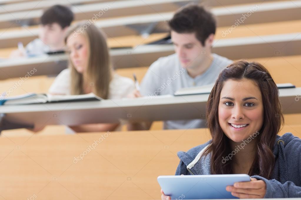 Smiling student taking notes with tablet pc Stock Photo by ...