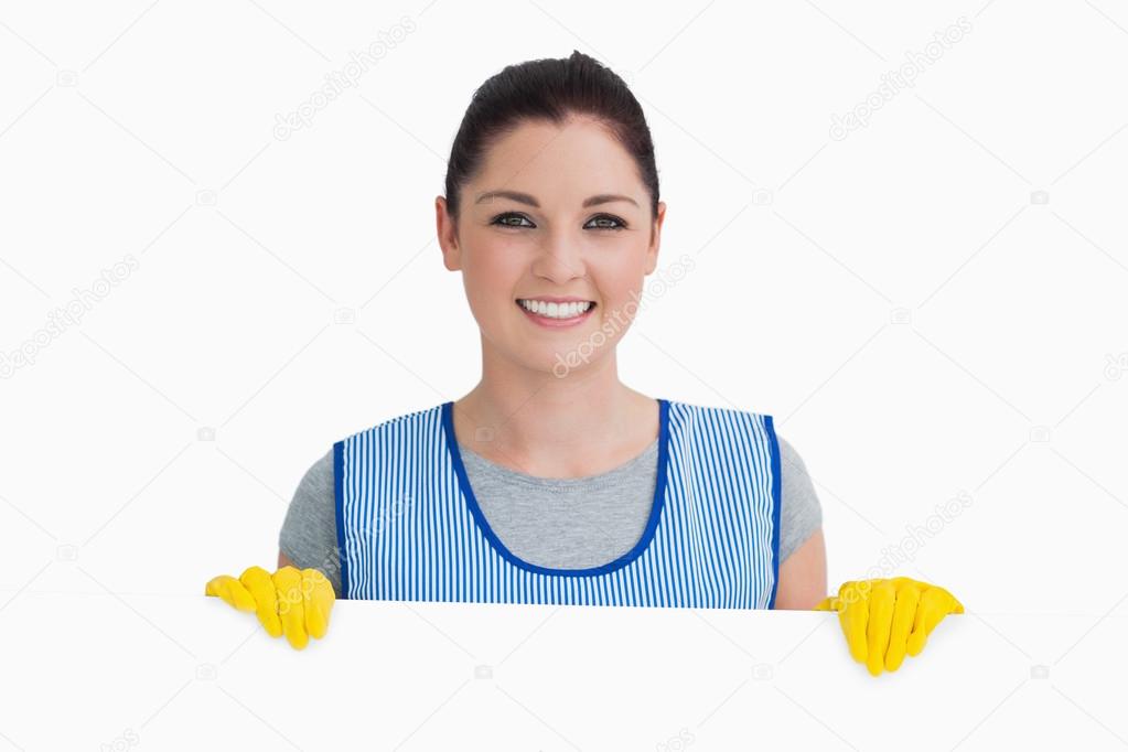 Smiling cleaning woman showing a white panel Stock Photo by ...