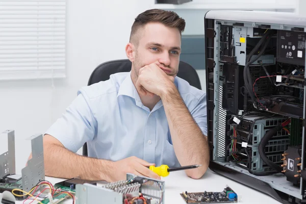 Thoughtful hardware professional sitting by an open cpu - Stock Image ...