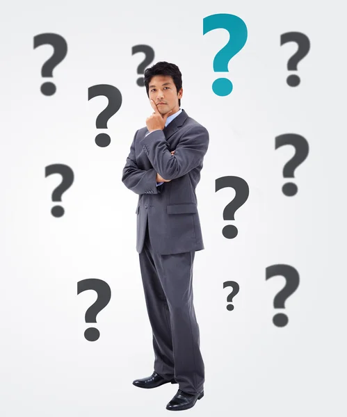 Businessman thinking surrounded by question marks — Stock Photo ...