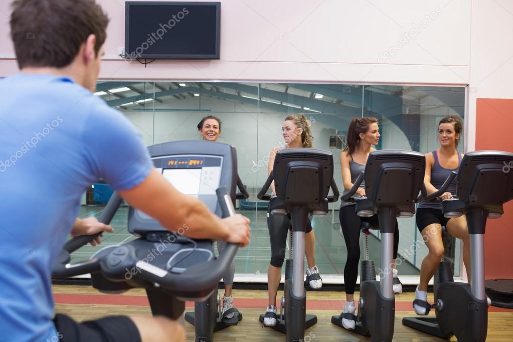 Happy women at spinning class Stock Photo by ©Wavebreakmedia 24095017