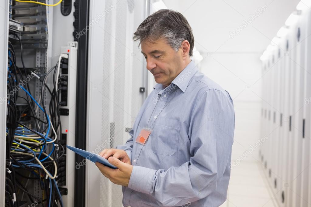 Technician checking the server with tablet pc — Stock Photo © Wavebreakmedia #24097479