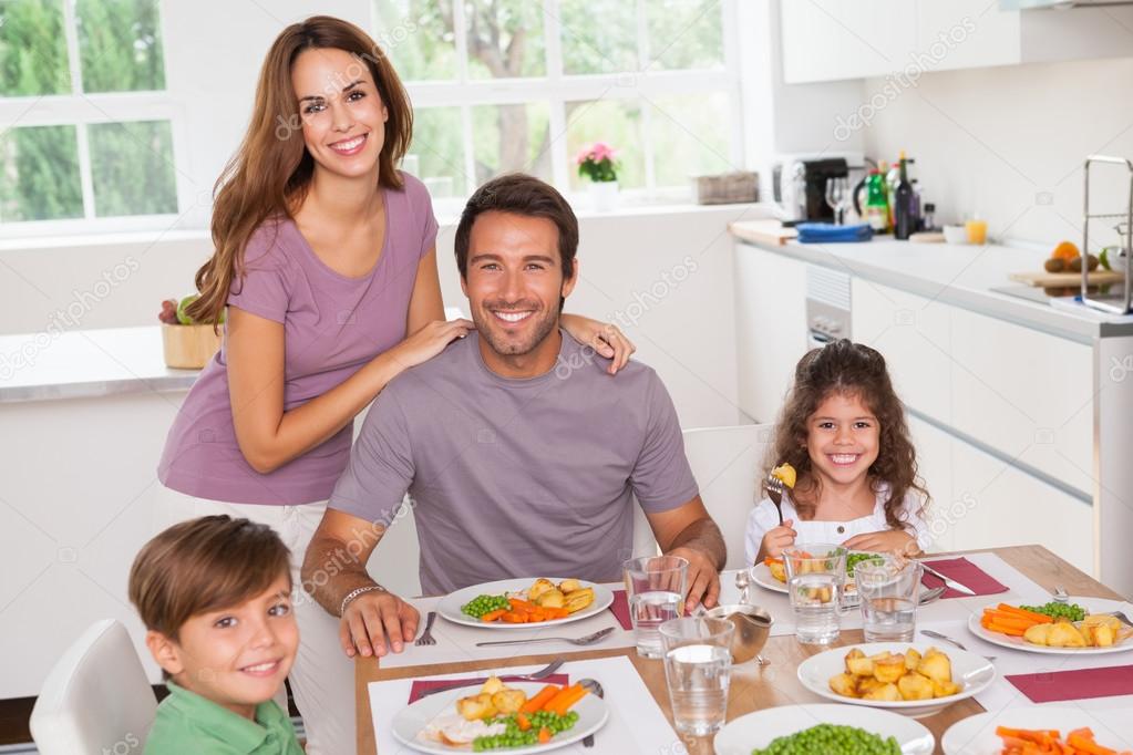 Family smiling at the dinner table — Stock Photo © Wavebreakmedia #24116283