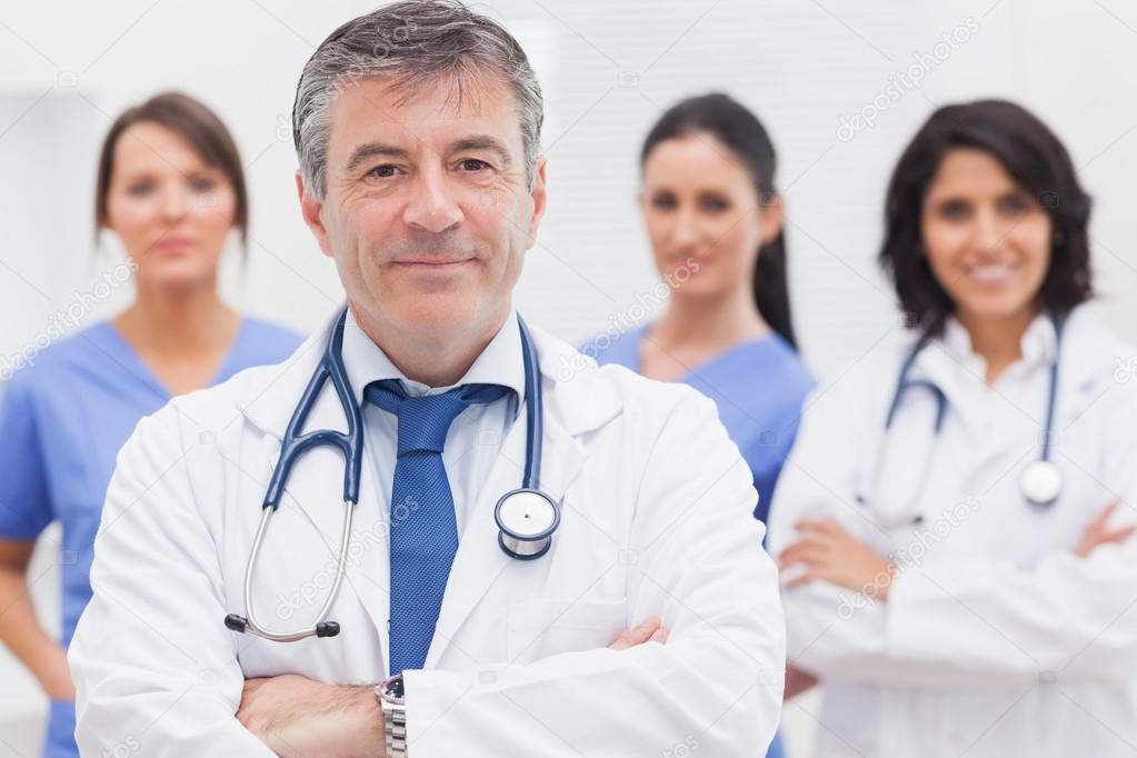 Doctor and his team smiling — Stock Photo © Wavebreakmedia #24117303