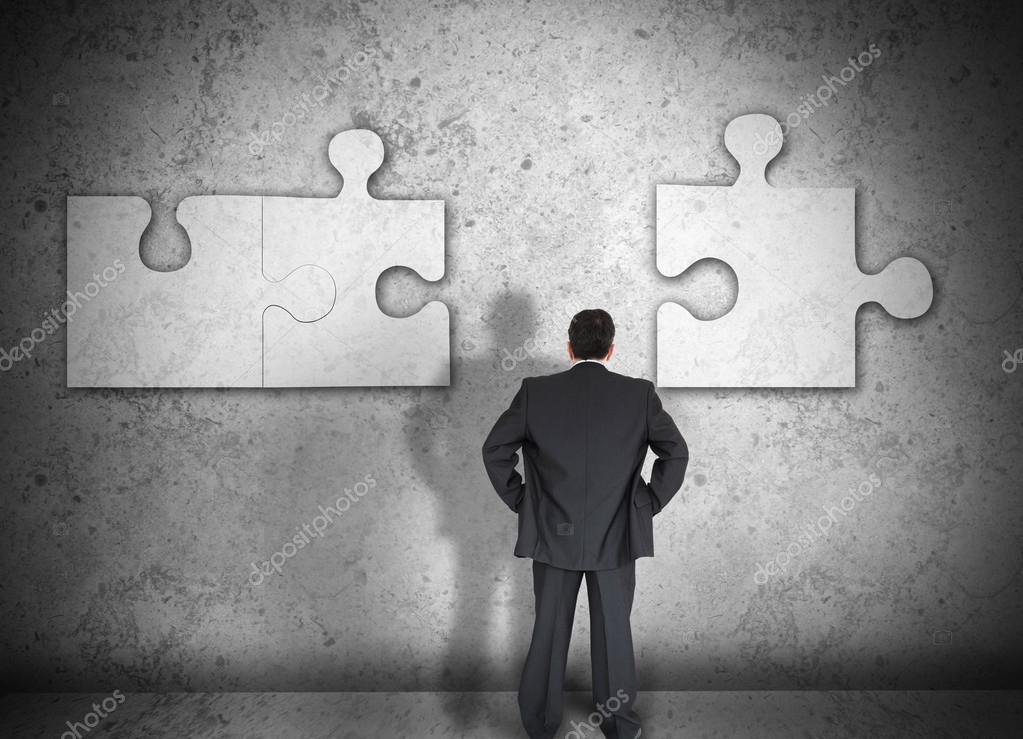 Businessman figuring out puzzle pieces — Stock Photo © Wavebreakmedia ... Businessman figuring out puzzle pieces — Stock Photo © Wavebreakmedia ...