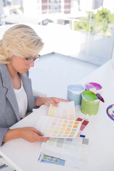 Focus interior designer looking at colour charts - Stock Image - Everypixel