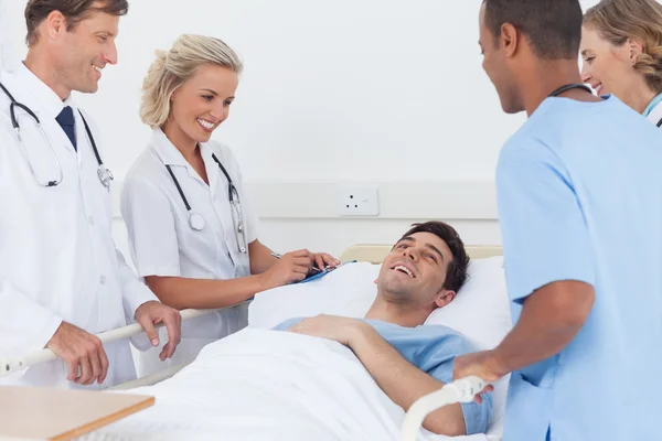 Medical team around the bed of a patient — Stock Photo © Wavebreakmedia ...