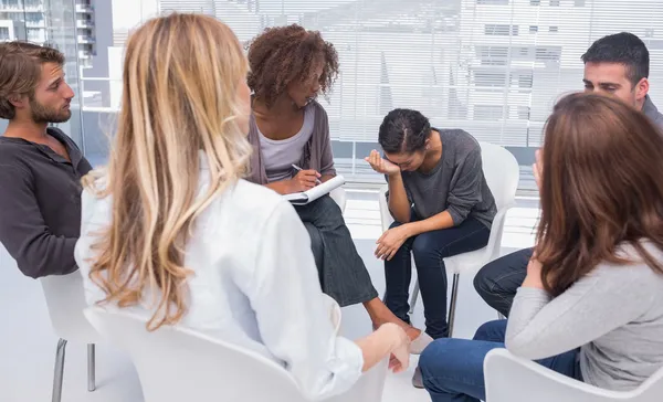Group therapy session with one woman crying - Stock Image - Everypixel