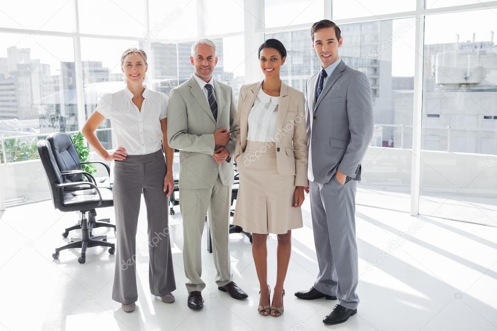Smiling business standing in line Stock Photo by ©Wavebreakmedia 25725575