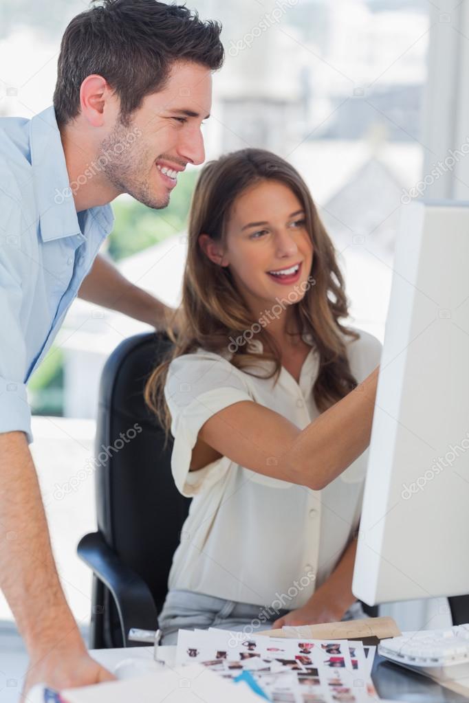 Two photo editors working together on a computer Stock Photo by ...