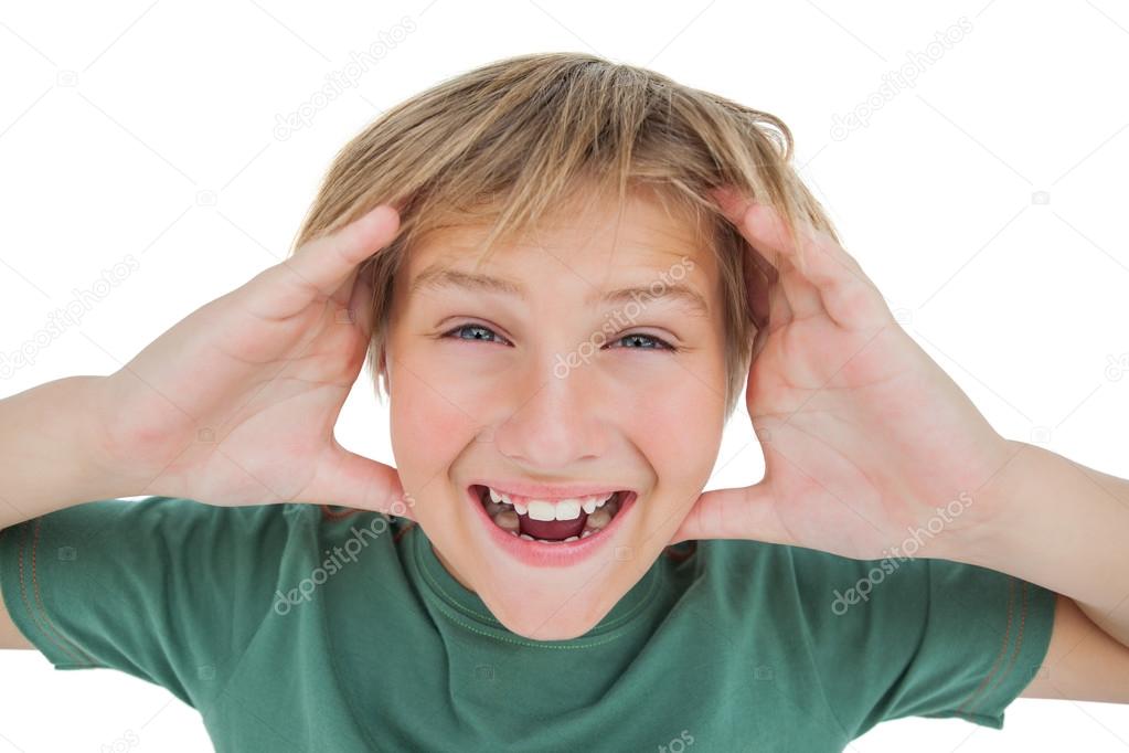 Amazed boy smiling with hands raised Stock Photo by ©Wavebreakmedia ...