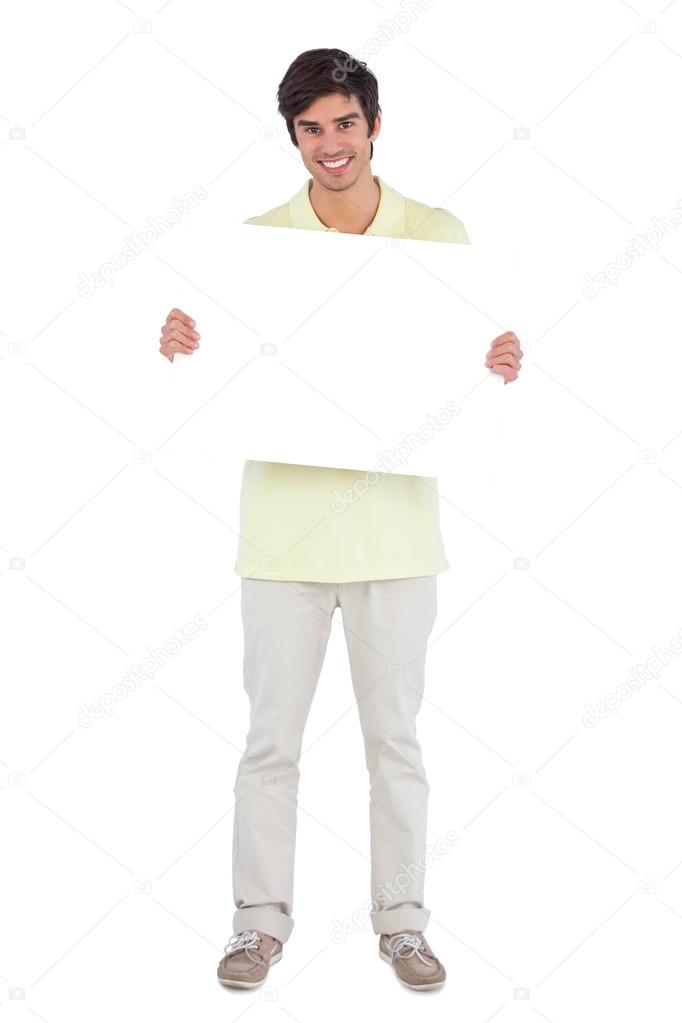 Smiling man holding empty sign — Stock Photo © Wavebreakmedia #28050523