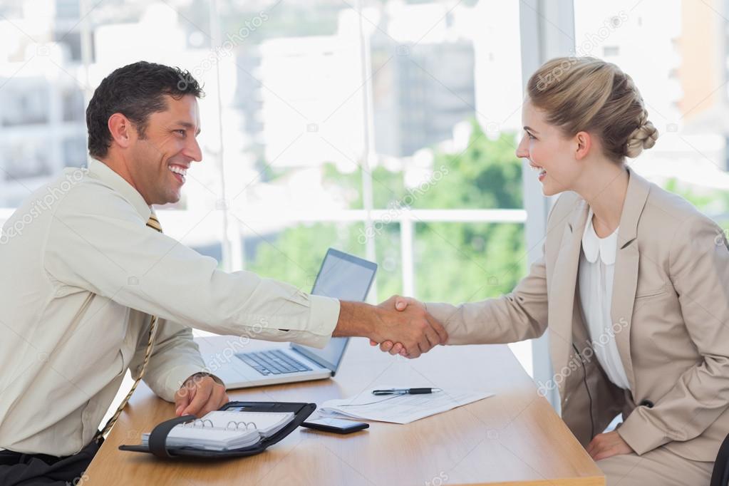 Blonde woman shaking hands while having an interview Stock Photo by ...