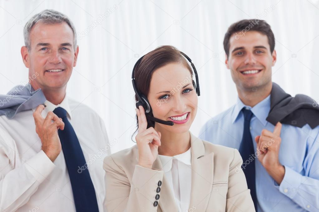Smiling call center agent posing with her work team Stock Photo by ...
