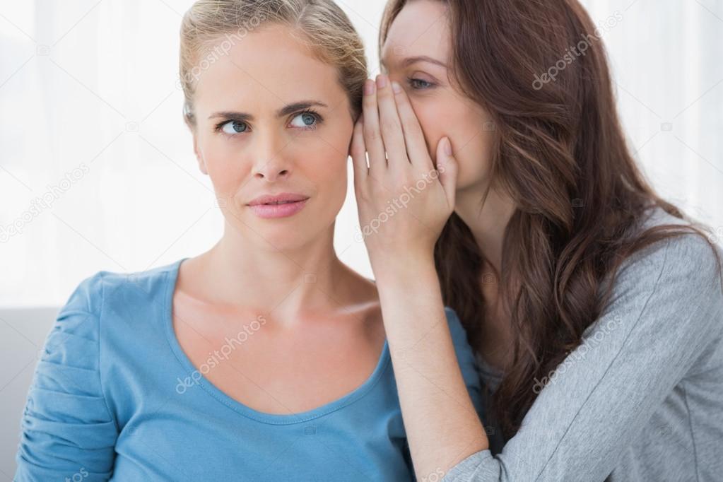Blond woman hearing a secret from her friend — Stock Photo ...