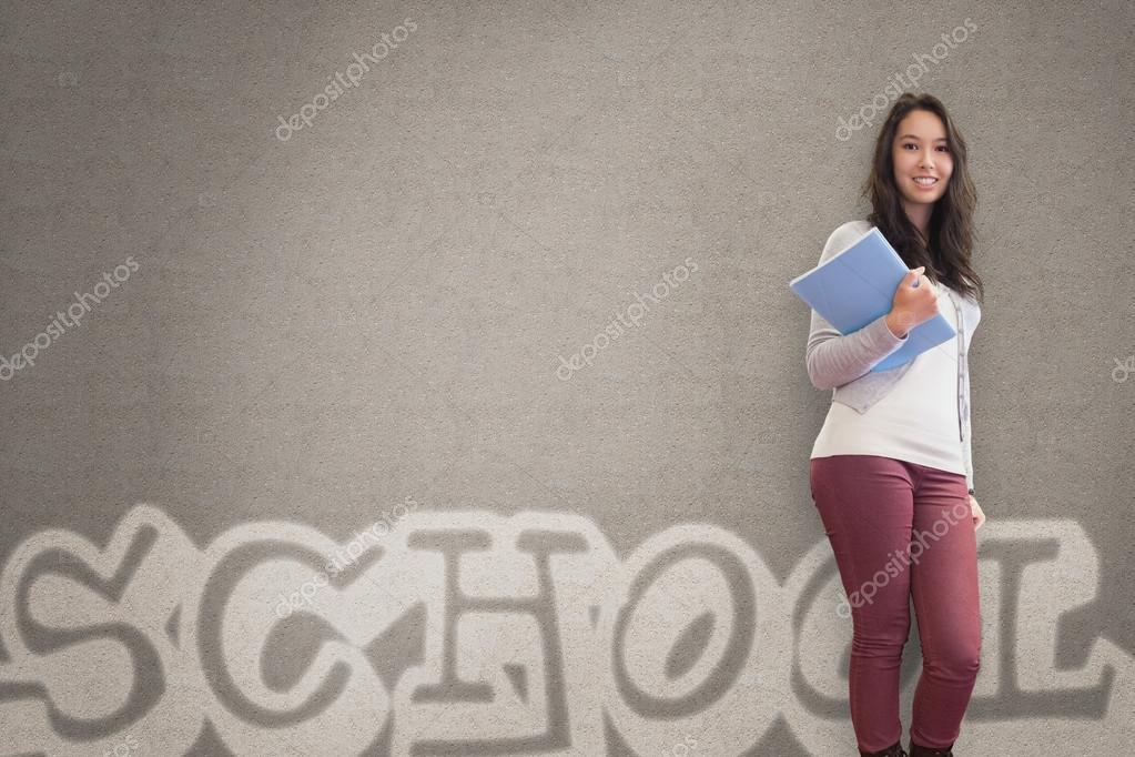Cheerful student holding notebook posing — Stock Photo © Wavebreakmedia ...