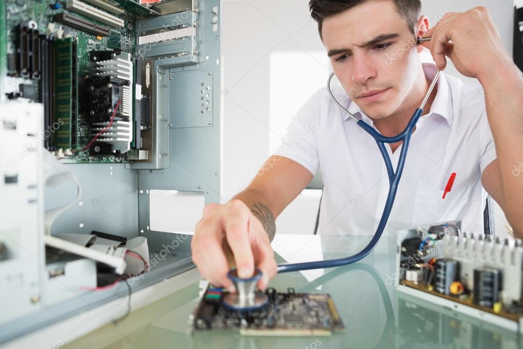 Handsome focused computer engineer holding stethoscope — Stock Photo ...