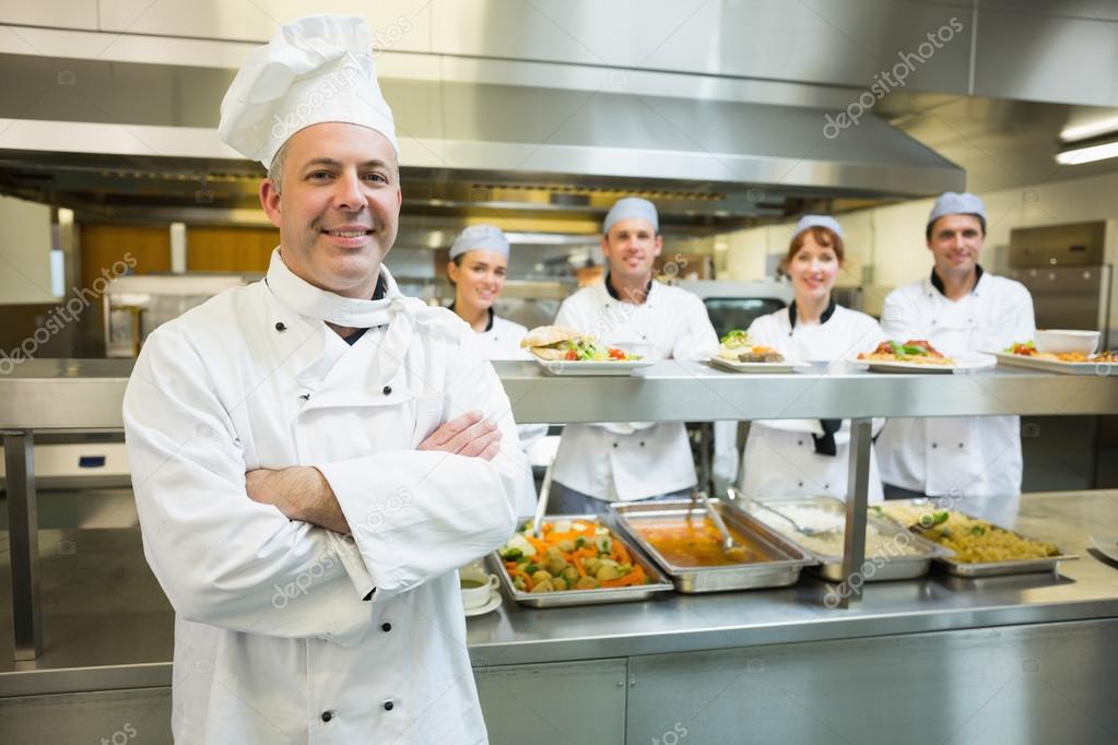 Proud mature head chef posing in a modern kitchen — Stock Photo ...