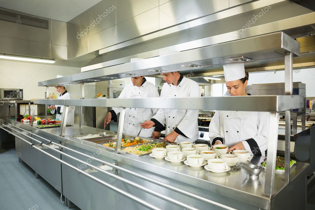 Four chefs working in a big kitchen — Stock Photo © Wavebreakmedia ...