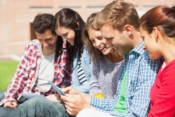 Five students sitting on the grass using tablet Stock Photo by ...