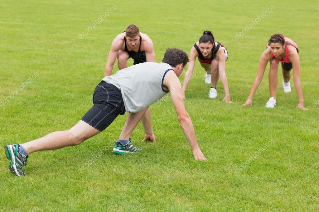Young people doing stretching exercise at the park Stock Photo by ...