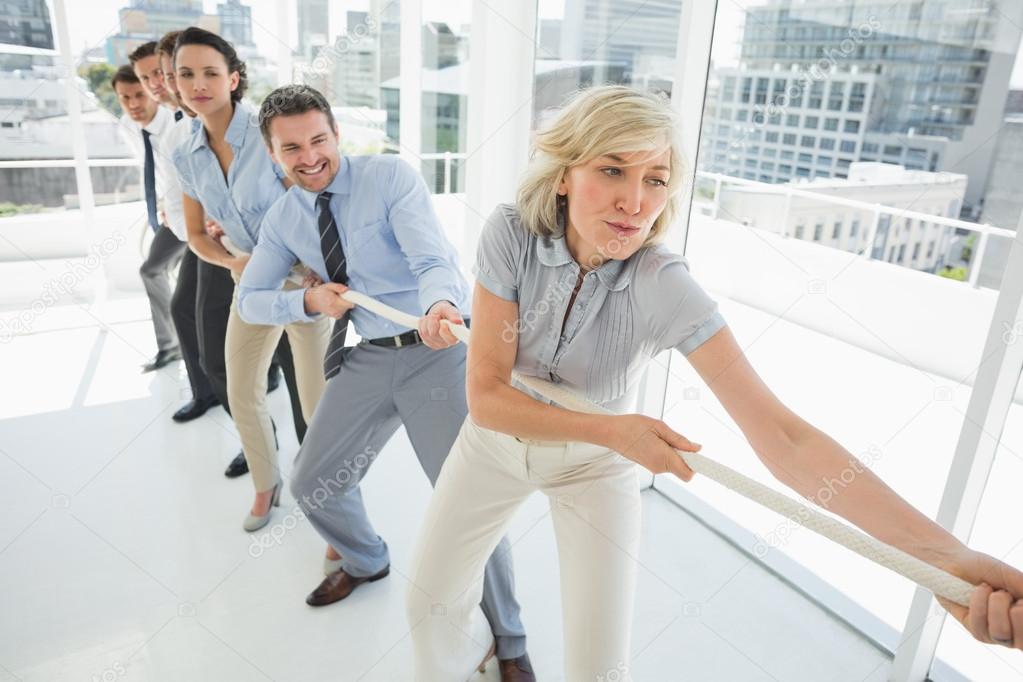 Group of business people pulling rope in office Stock Photo by ...