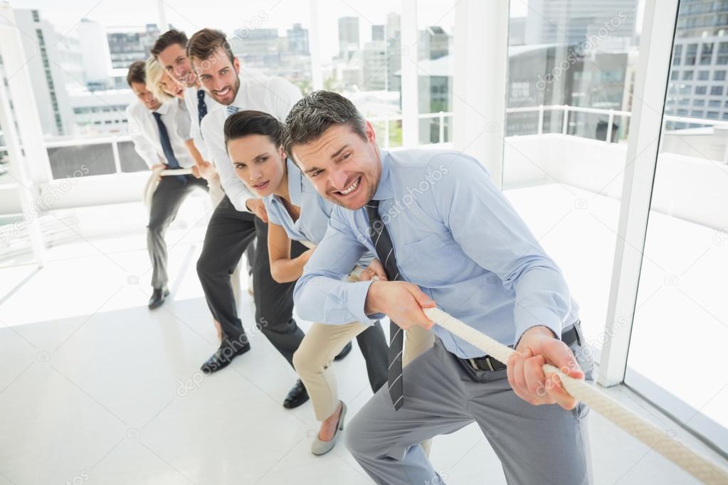 Group of business people pulling rope in office — Stock Photo ...