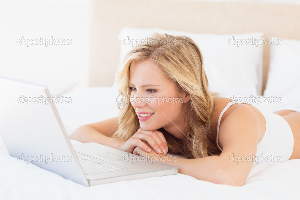 Blonde watching her laptop — Stock Photo © Wavebreakmedia #42922909