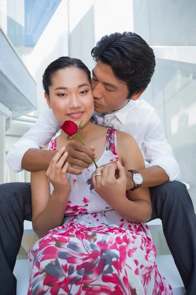 Man offering a red rose to girlfriend - Stock Image - Everypixel